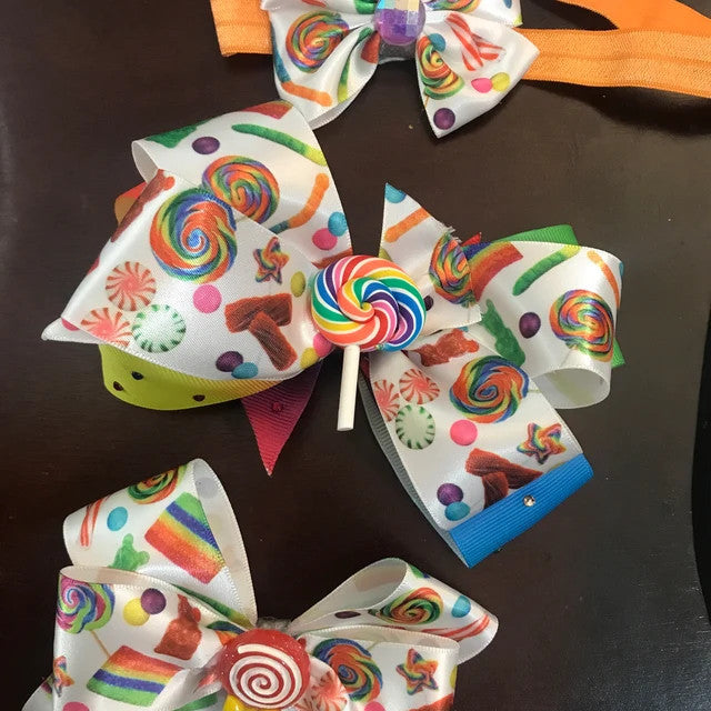 Candy theme ribbon with lollipops, gummy bears, and mints in rainbow ...