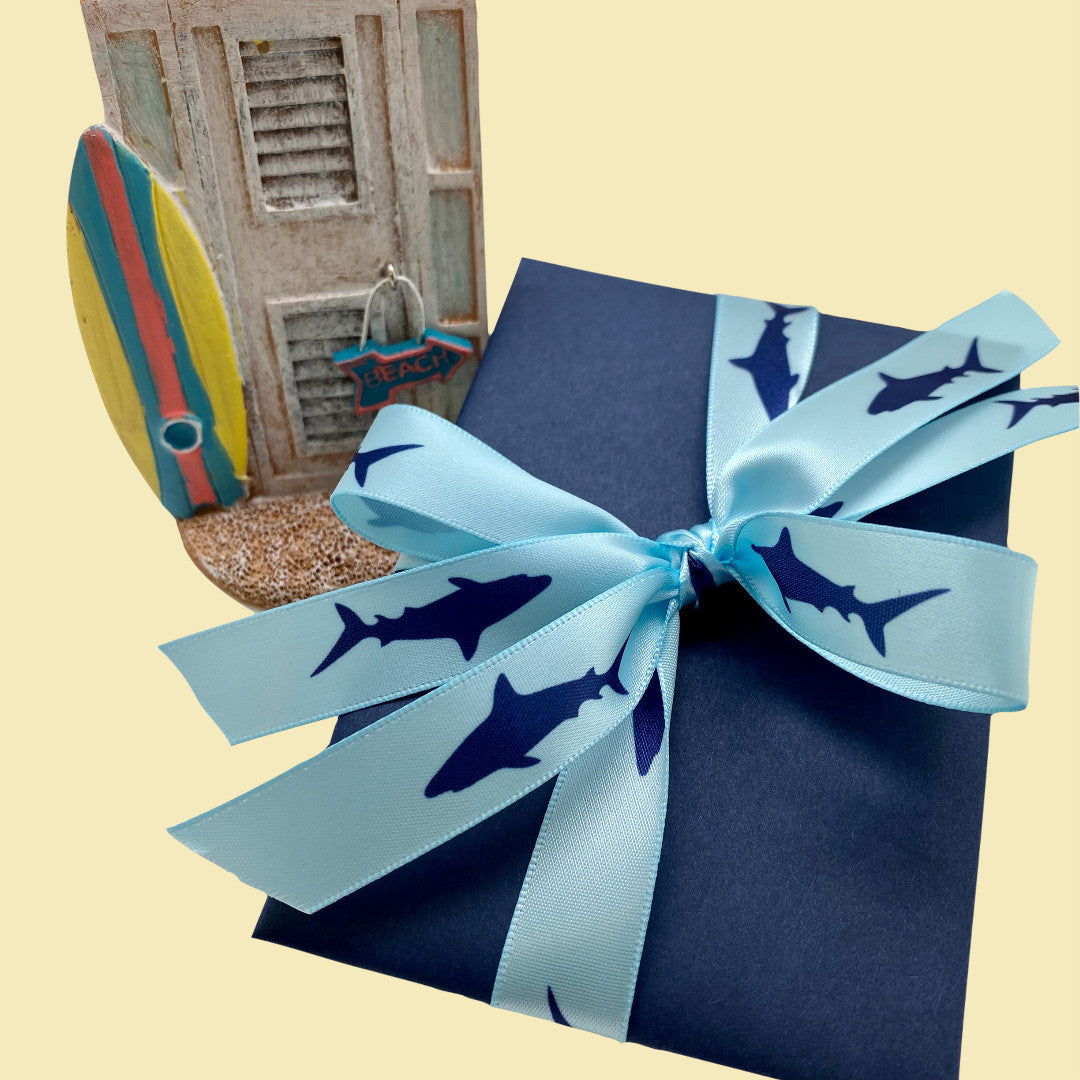 Navy blue shark silhouettes printed on 5/8" light blue single face ...